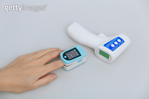 Pulse oximeter and thermometer gun on white background. Measuring ...