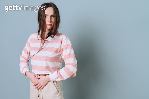 The girl strained her face with disheveled hair, malaise, sore face ...