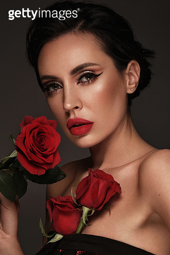 Beautiful Brunette Woman Iwith A Classic Make Up Red Lips Holding
