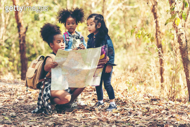 Group family children checking map for explore and find directions in ...