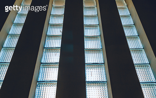 Old glass wall blocks in the wall of a Soviet-style house. Scattered ...