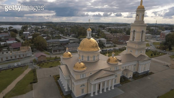 Aerial view of the beautiful white church with a tower and gold domes ...