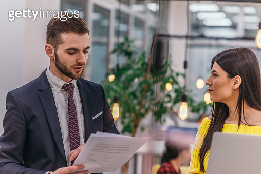 Manager explaining to his employee how to finish her tasks. Colleagues ...