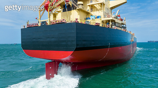 Propeller of large ship spinning power working and water splash ...