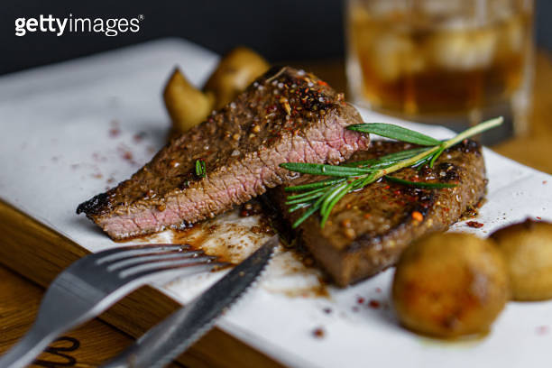 Fresh grilled meat. Beef steak medium rare with rosemary brunch and ...