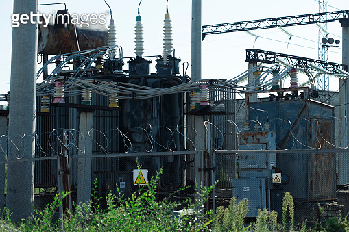 old damaged high voltage transformer substation. rust on structures ...