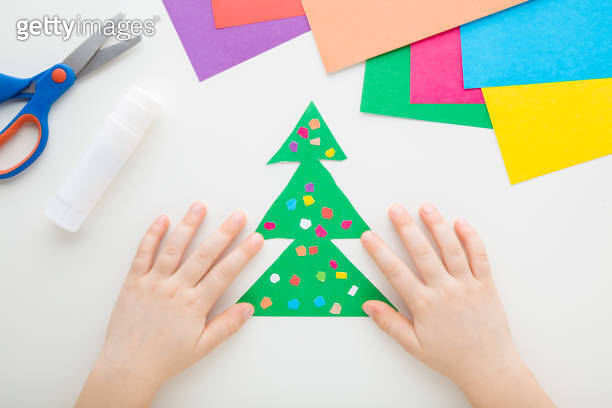 Little child hands creating green Christmas tree with colorful balls ... Little child hands creating green Christmas tree with colorful balls ...
