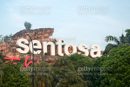 The sign of the Sentosa Island surrounded by tropical trees, Singapore ...