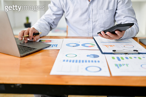 cropped image, Professional Asian male financial analyst working at his ...