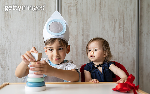 Preschool boy and toddler girl brother and sister wearing costumes ...