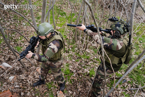 Two men top view portrait of soldiers in camouflage uniform armed with ...