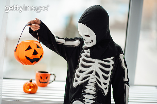 Portrait of candid authentic gen Z boy have fun in skeleton costume at ...
