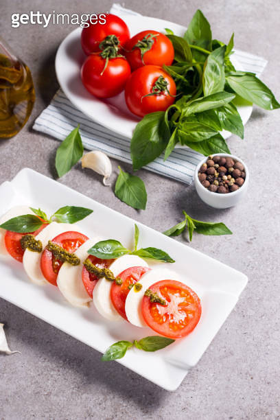 Close-up photo of caprese salad with ripe tomatoes, basil, buffalo ...