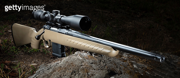 Brown bolt action rifle with a scope on a log 이미지 (1447365089) - 게티이미지뱅크