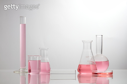 Experiment with pink fluid in glassware test tube beaker , lab ...