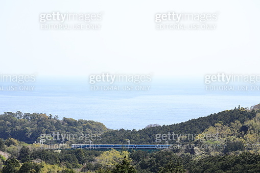 train running along seaside of Izu, Shizuoka, Japan (Odoriko, E257 ...