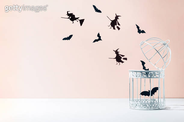 Creative minimal concept with bird cage, bats silhouettes and witches ...