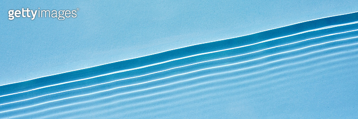 Abstract blue background Horizontal waves, ripples on clear water ...