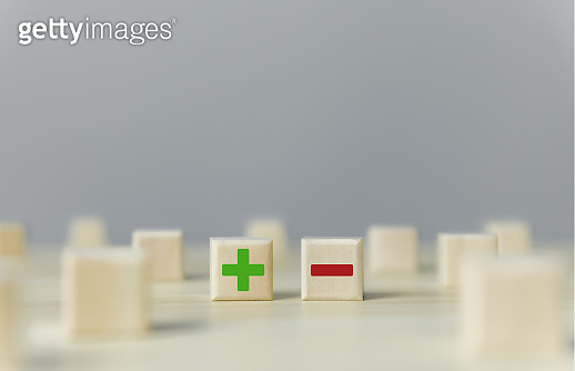wooden cube block Show plus and minus symbols. The concept of opposites ...