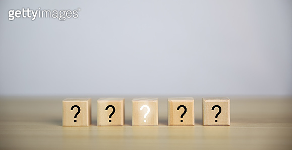 A wooden cube block showing a question mark icon. concept alternative ...