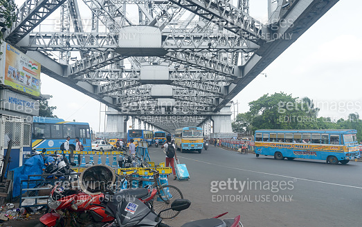 Howrah Bridge traffic on a busy afternoon. Large group of people in the ...