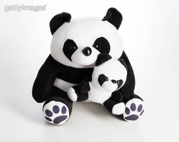 Children's soft toy black and white panda with a cub on a white ...