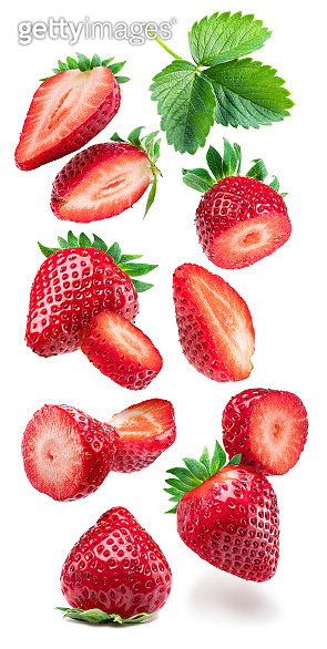 Strawberry and strawberry slices flying in the air slices on white ...
