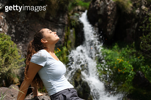 Woman relaxing and breathing in a little waterfall 이미지 (1443236242 ...