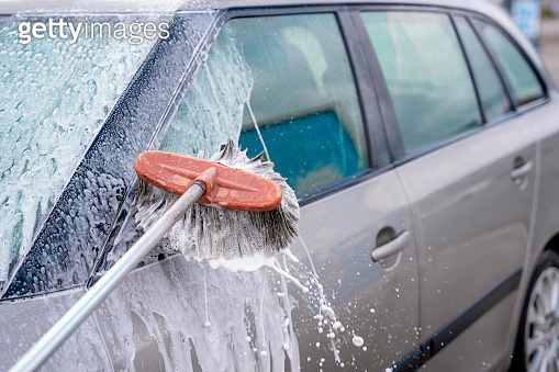 a washing a car with a jet wash in the open air. Cleaning and ...