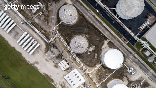 Fossil fuel storage tanks connected with pipelines in the industrial ...