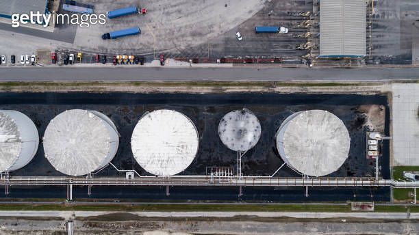 Fossil fuel storage tanks connected with pipelines in the industrial ...