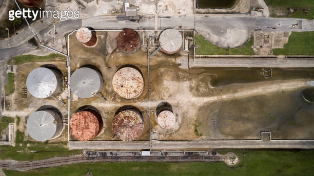 Fossil fuel storage tanks connected with pipelines in the industrial ...