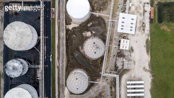 Fossil fuel storage tanks connected with pipelines in the industrial ...