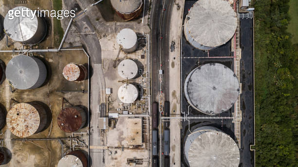 Fossil fuel storage tanks connected with pipelines in the industrial ...