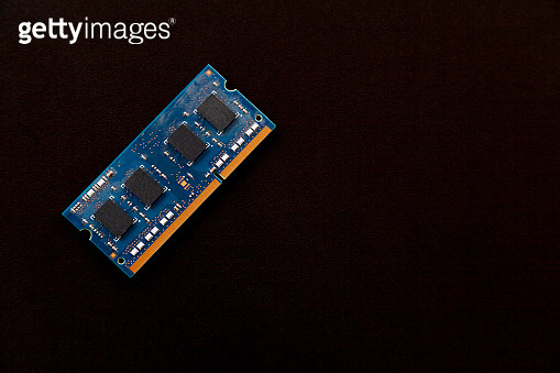 Computer memory chip placed on top of a black table. Connections and ...