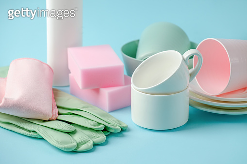 Kitchen cleaning concept, front view of dishes, dish washing sponge ...