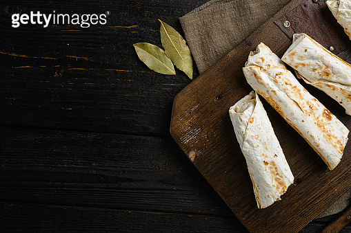 A delicious doner doner kebab wrap with meat, lettuce, tomato, red ...