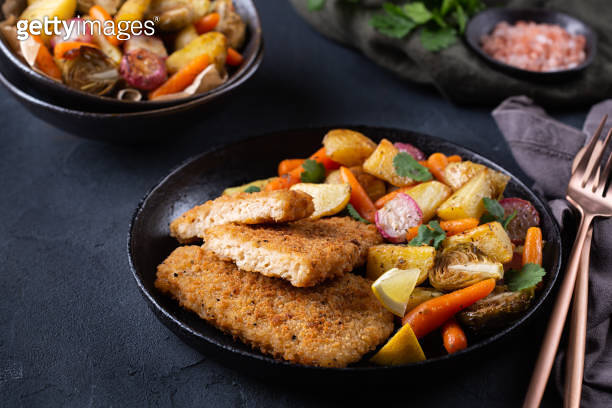 Vegan Plant based fish with crispy batter and roasted vegetables ...