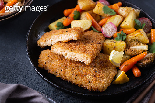 Vegan Plant based fish with crispy batter and roasted vegetables ...