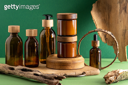 Glass brown containers for cosmetics with wooden lids. Cream, dropper ...