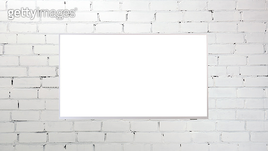 White screen LED TV on a brick white wall indoors. Living room. The ...