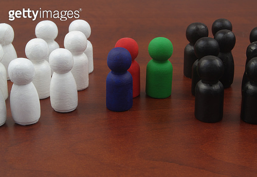Redd, green and blue people figures between two groups of white and ...
