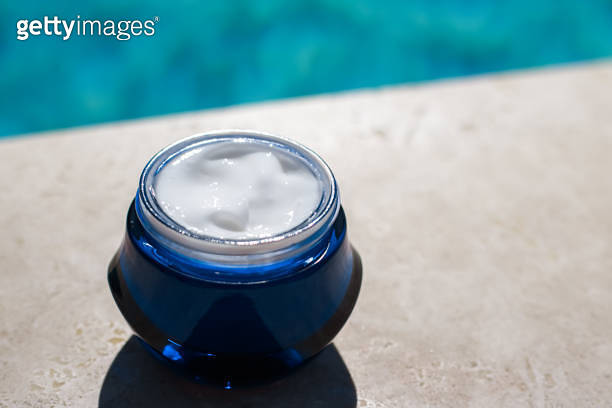 Moisturising beauty cream, skincare and spa cosmetics by swimming pool ...