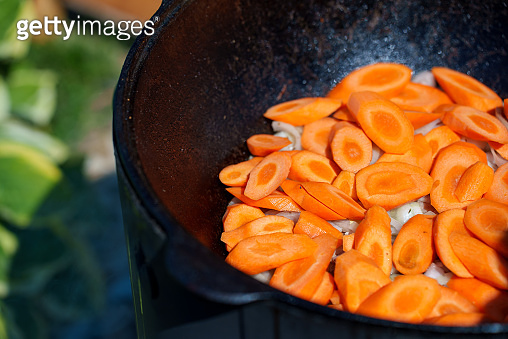 Carrot is cooked in cauldron on fire. Step by step cooking of Chorba ...