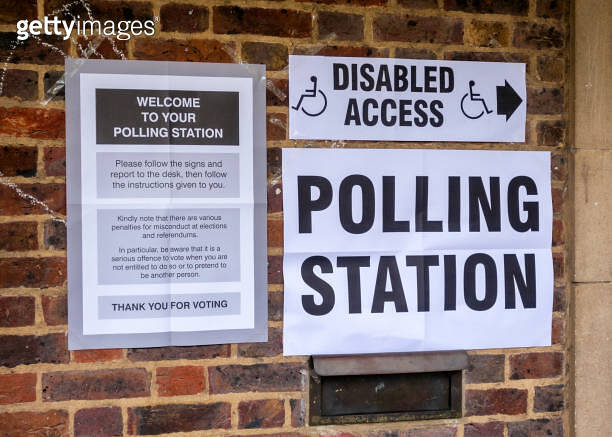 Polling Station sign and instructions on a wall outside a Polling ...