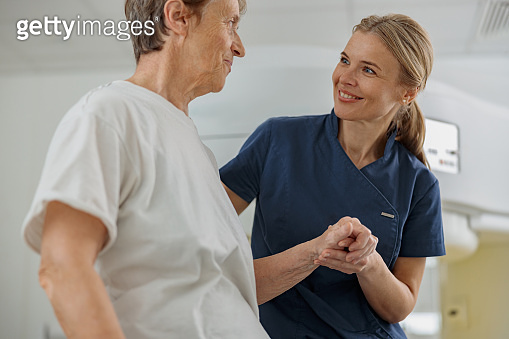 Close up of doctor radiologist help patient sit after procedure of MRI ...