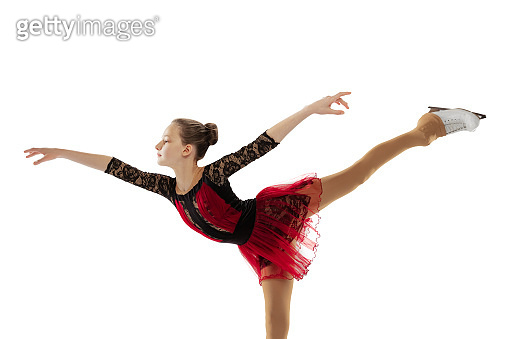 Portrait of little flexible girl, figure skating wearing stage attire ...