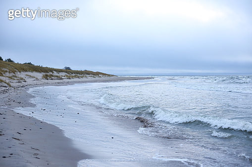 Cloudy overcast view with shoreline with small rocks near Baltic sea in ...