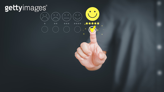 Man touching the virtual screen on the happy smiley face icon to give ...