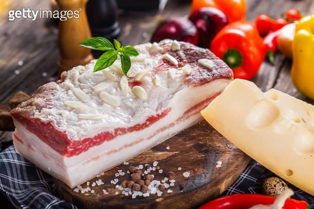 fresh lard pork lard with salt, on a kitchen cutting board, hard cheese ...